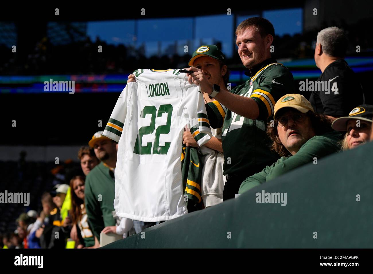 A Packers fan holds up a shirt before an NFL game between the New York ...