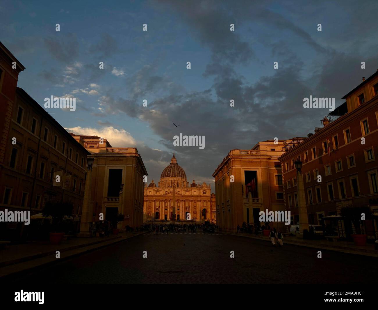 The St. Peter's Basilica is lit by the rising sun, in Rome, Sunday, Oct ...