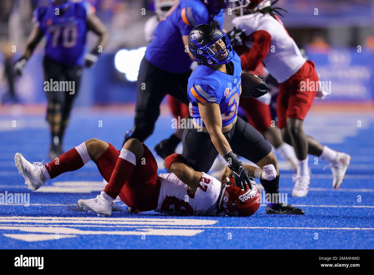 Boise State running back Elelyon Noa (36) is pulled down on a run by ...