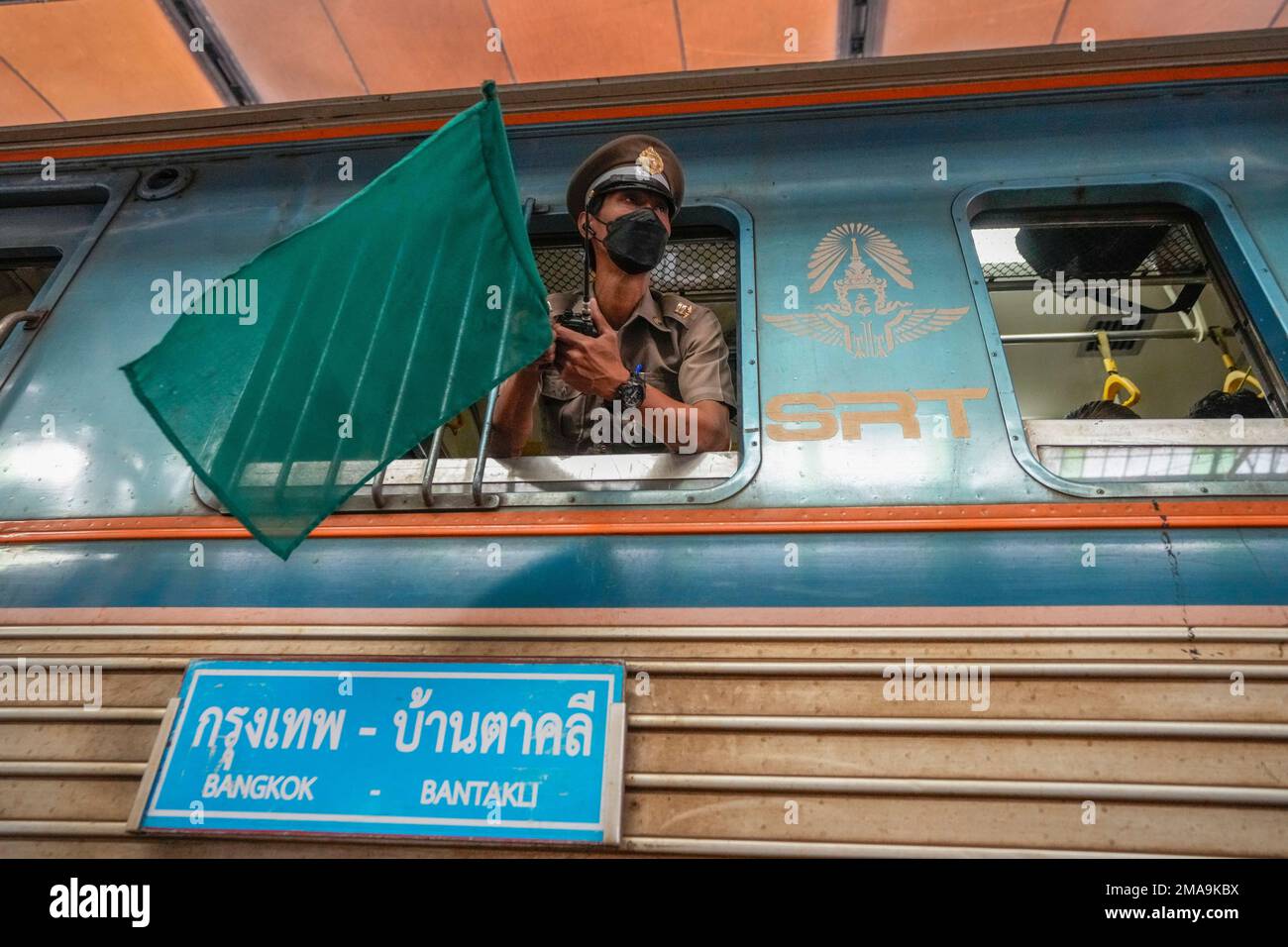 A train conductor waves the green flag signaling he's ready for ...