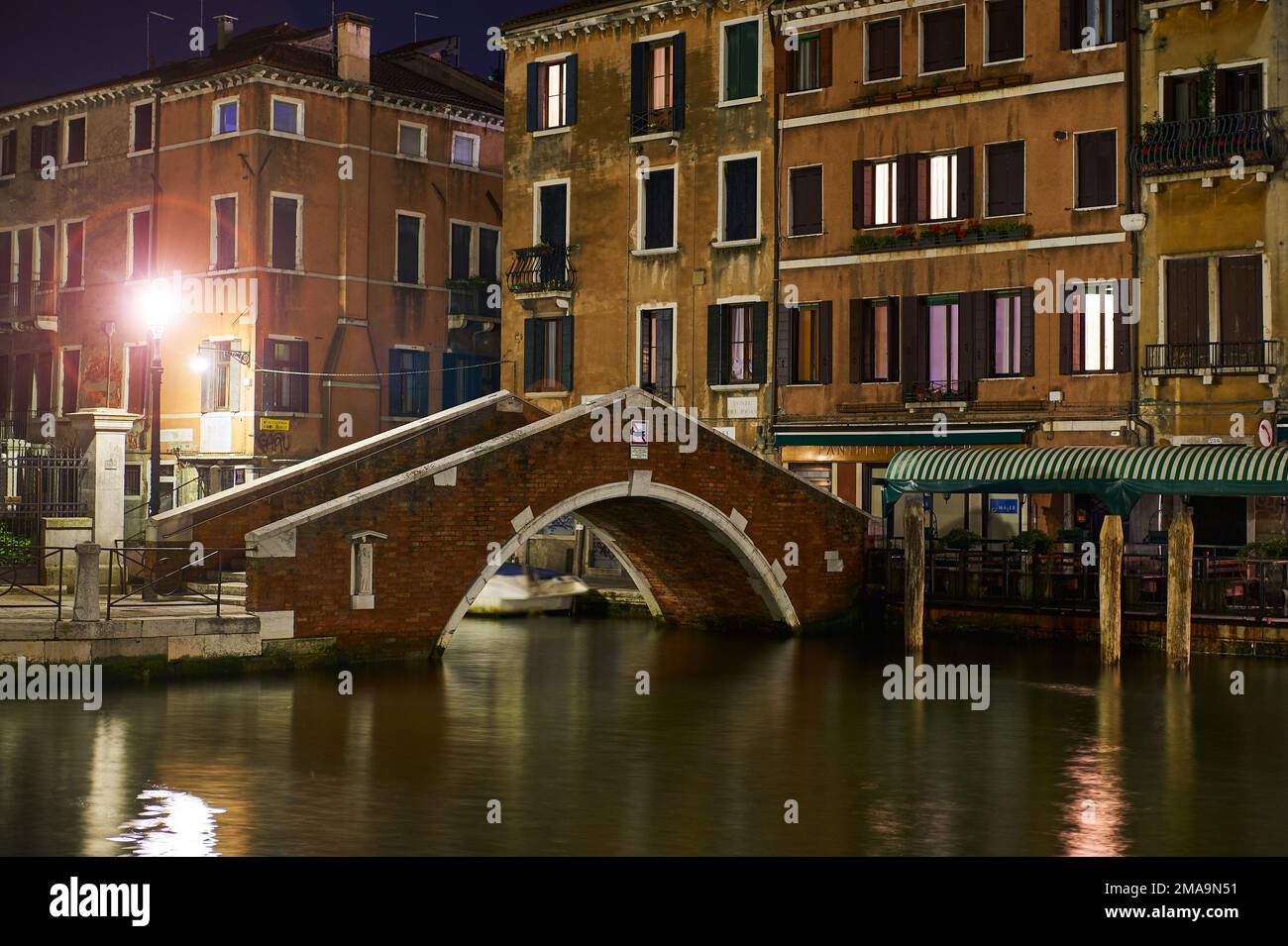 View of the city of Venice at night with a red brick bridge Stock Photo ...