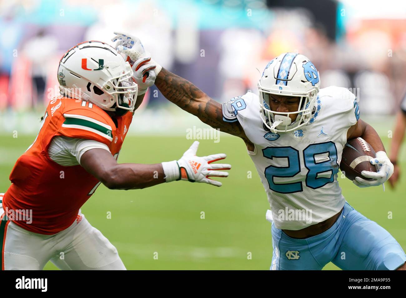 North Carolina running back Omarion Hampton (28) runs for yardage ...