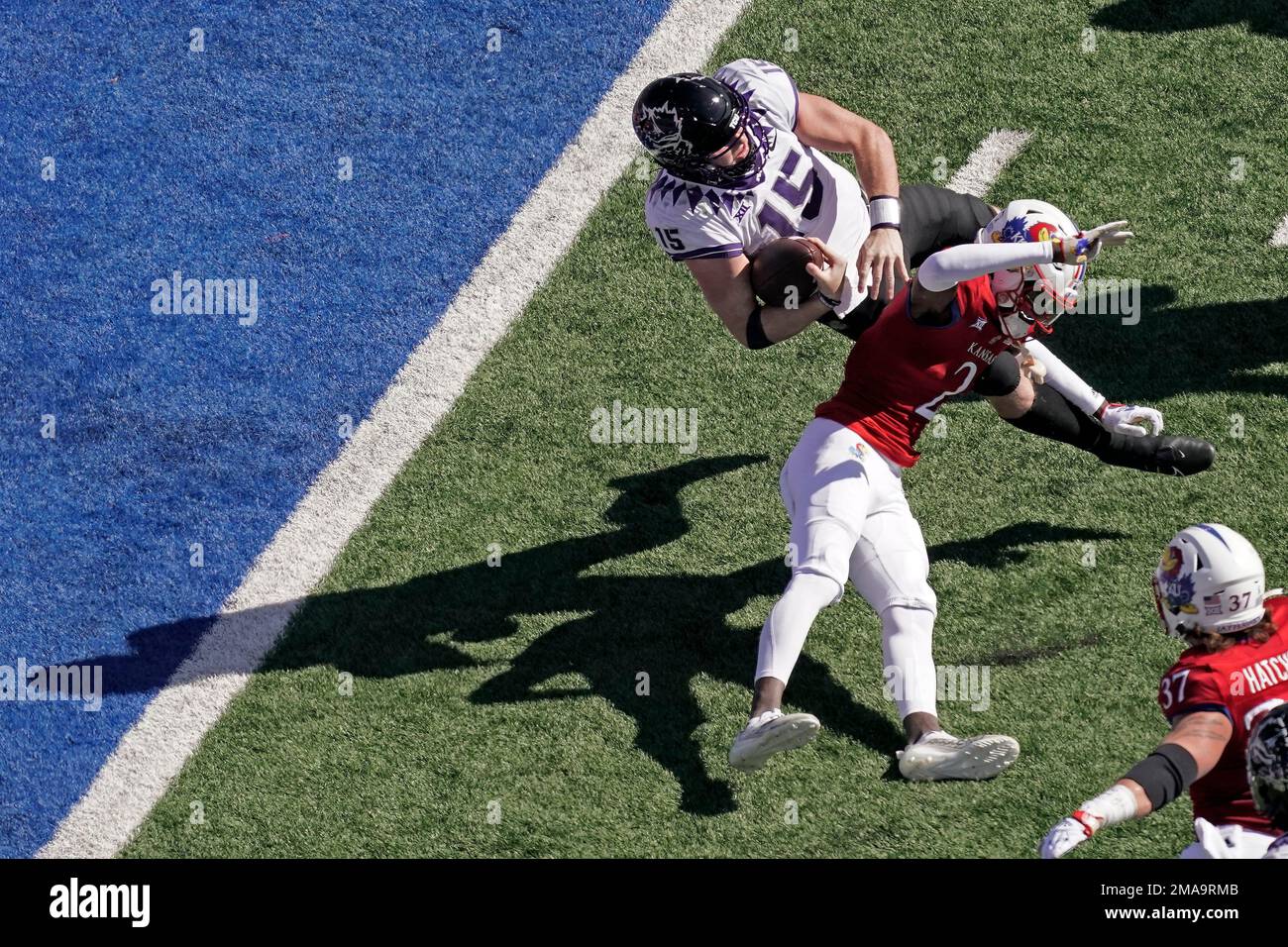 TCU quarterback Max Duggan (15) is upended by Kansas cornerback Cobee ...