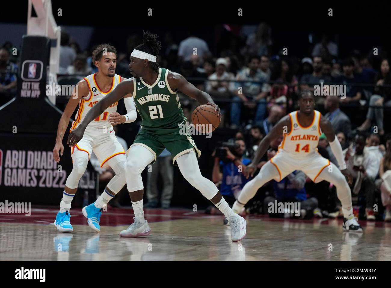 Trae Young of Atlanta Hawks guards Jrue Holiday of Milwaukee Bucks ...