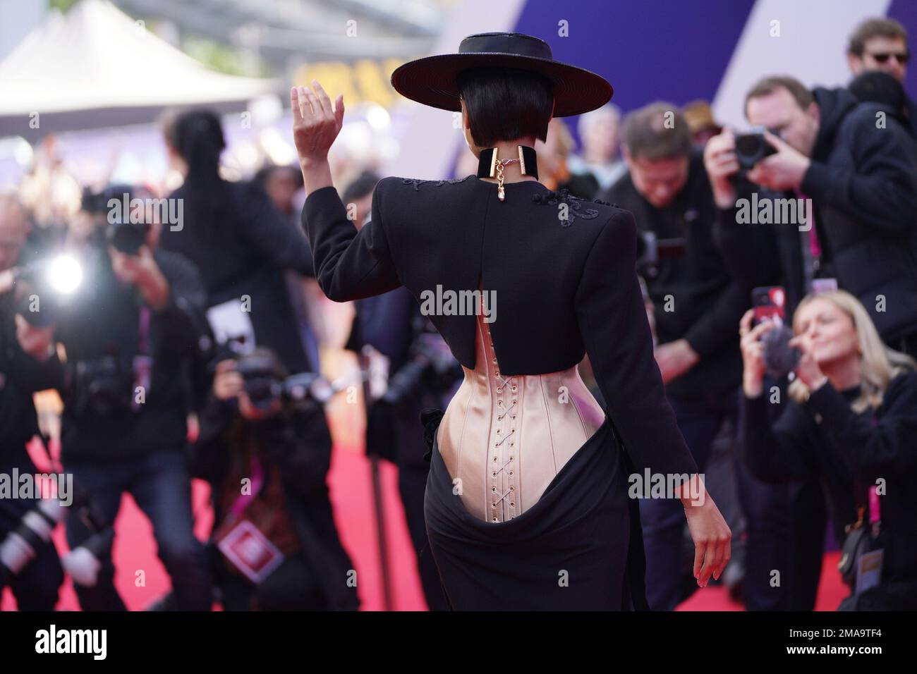 Taylor Russell waves upon arrival for the premiere of the film 'Bones ...