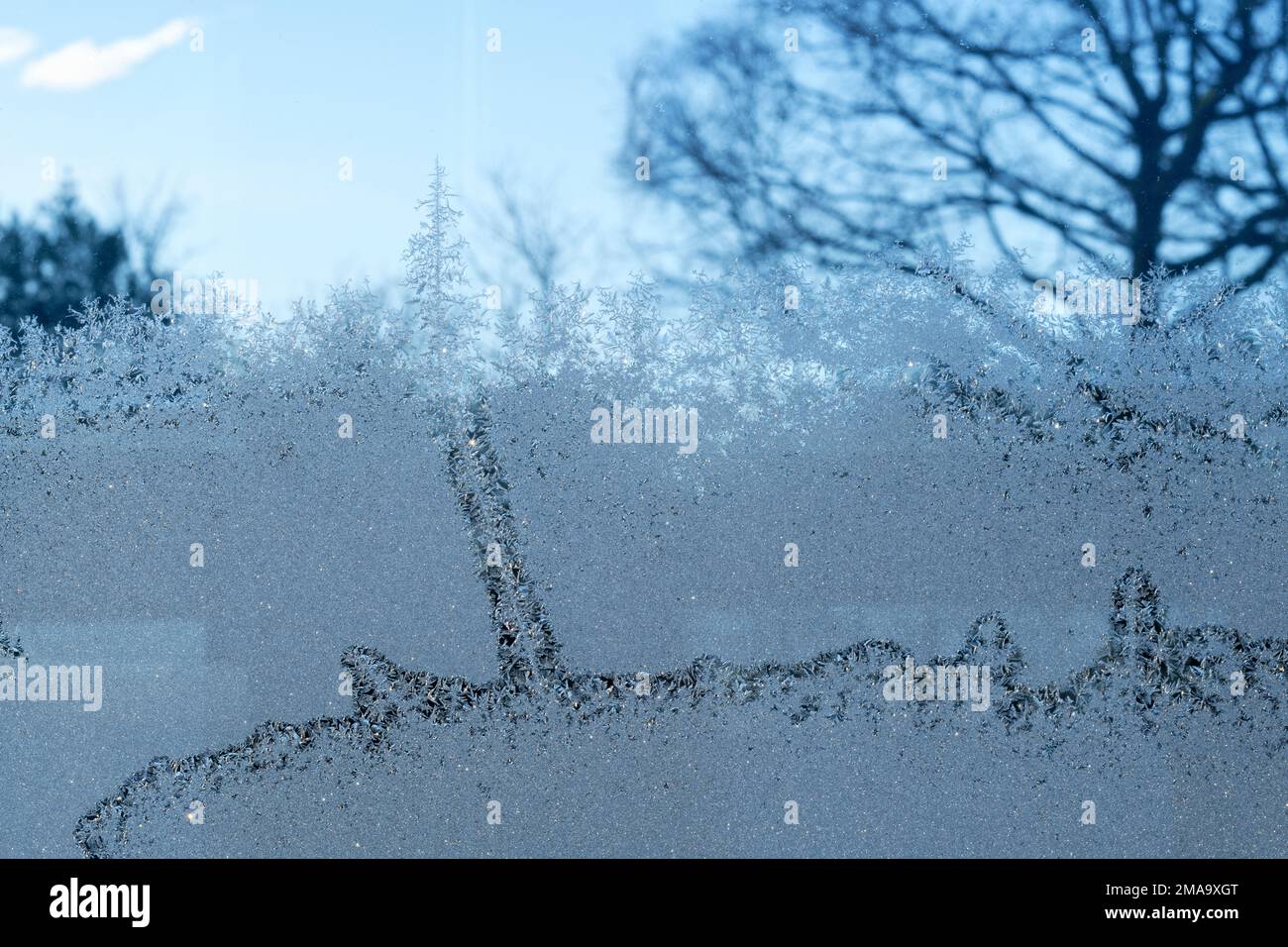 Ice crystals formed on glass. A window from inside looking out Stock ...