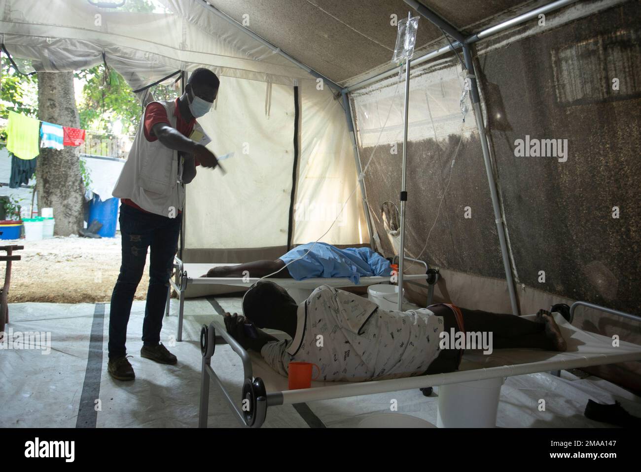 A worker at Doctors Without Borders (MSF) gives instruction to a ...