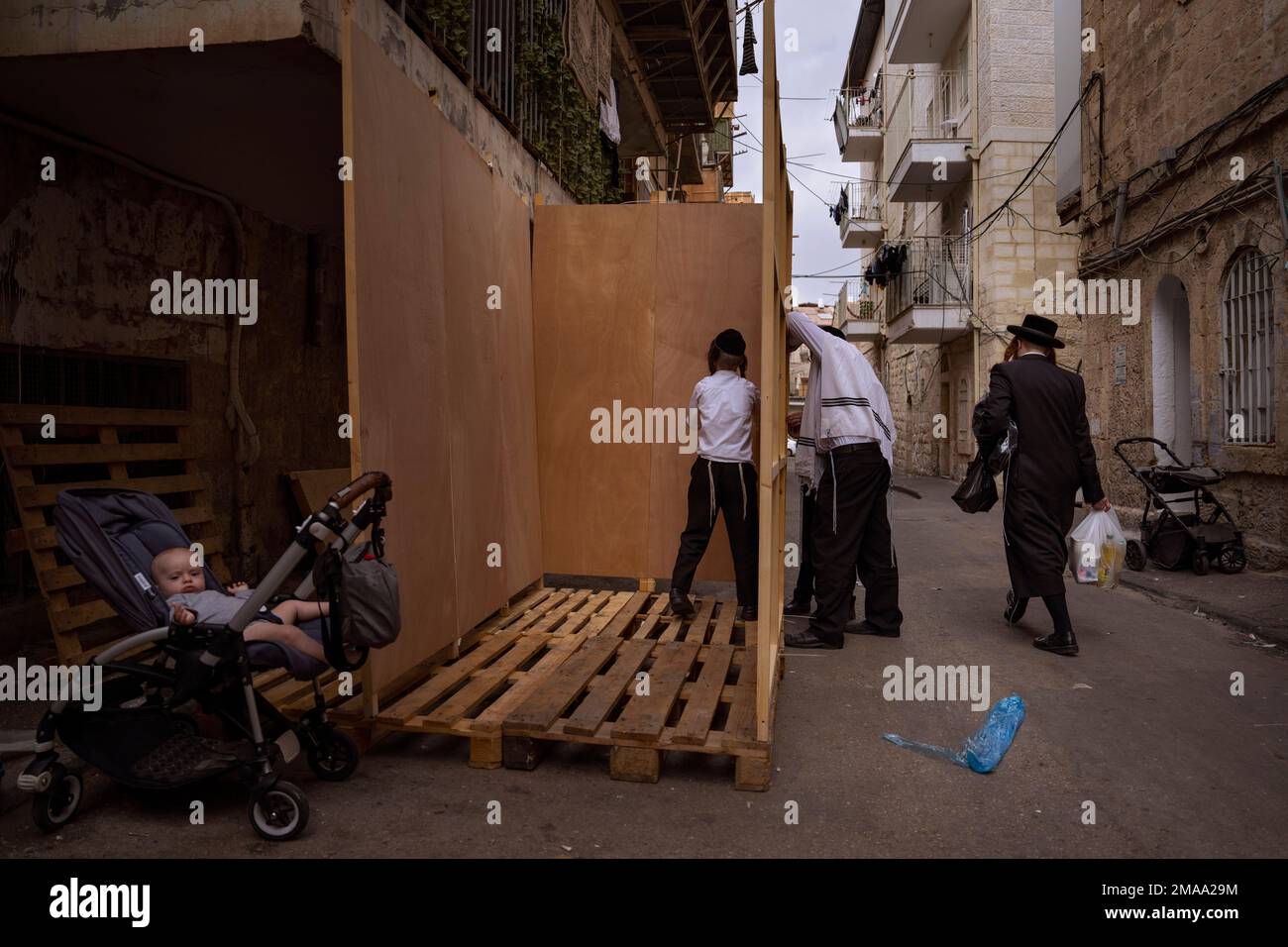 Ultra-orthodox Jews build a Sukkah, a temporary structure built for the ...
