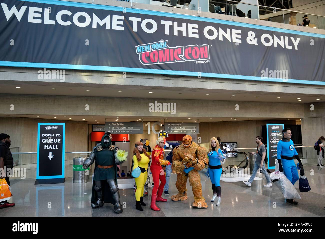 Attendees dressed as characters from Marvel's "Fantastic Four" pose ...