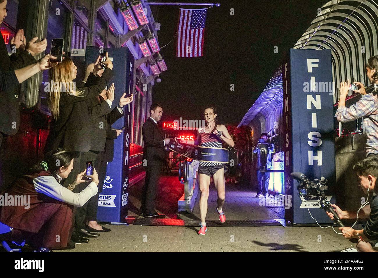 Elite runner Cindy Harris, from Indianapolis, Ind., breaks the tape to ...