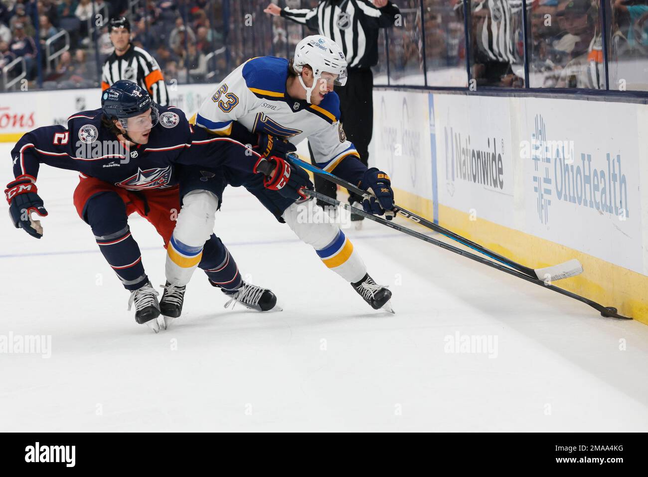 Columbus Blue Jackets' Andrew Peeke, left, and St. Louis Blues' Jake ...