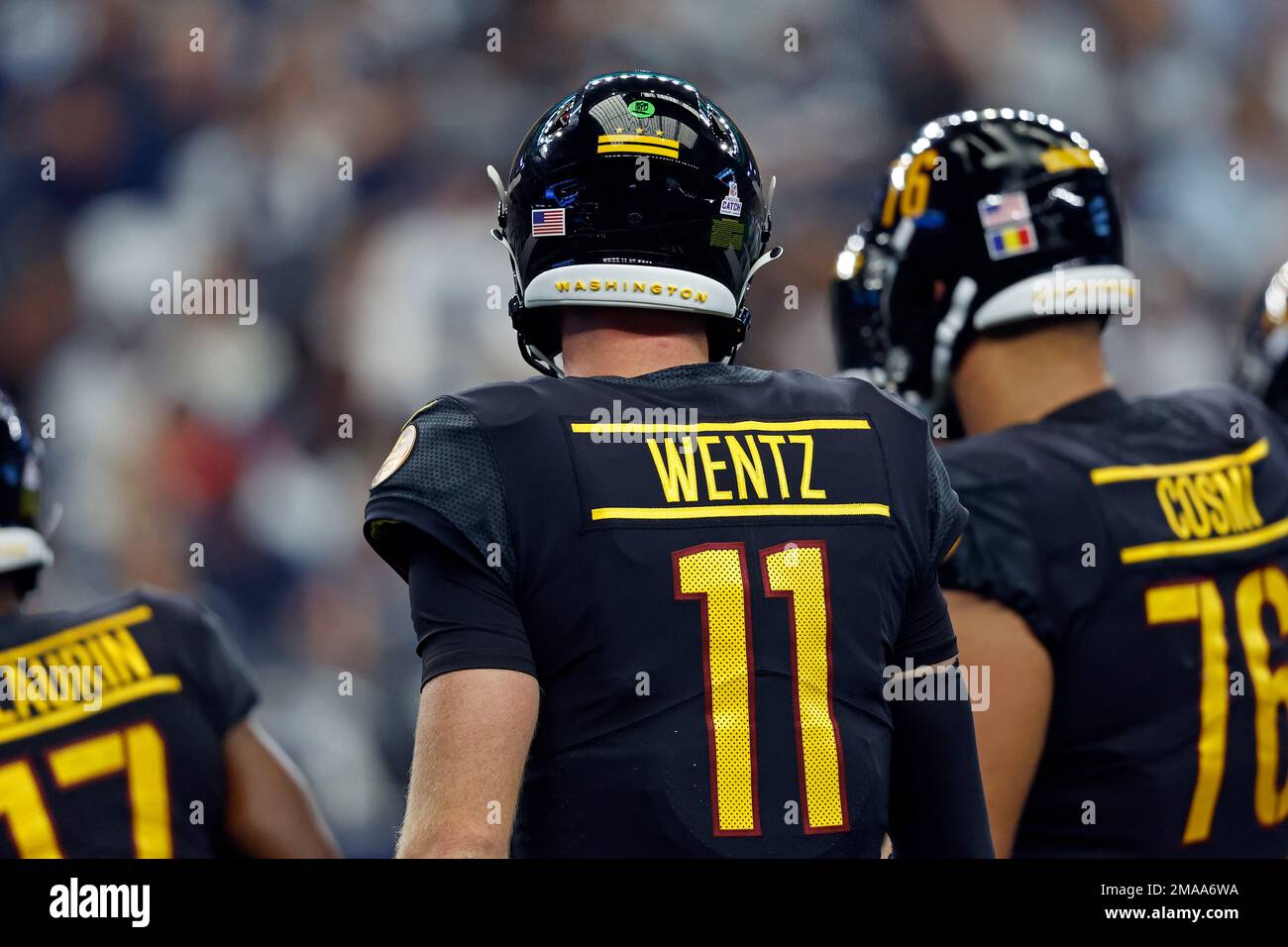 Washington Commanders quarterback Carson Wentz (11) wears and ...