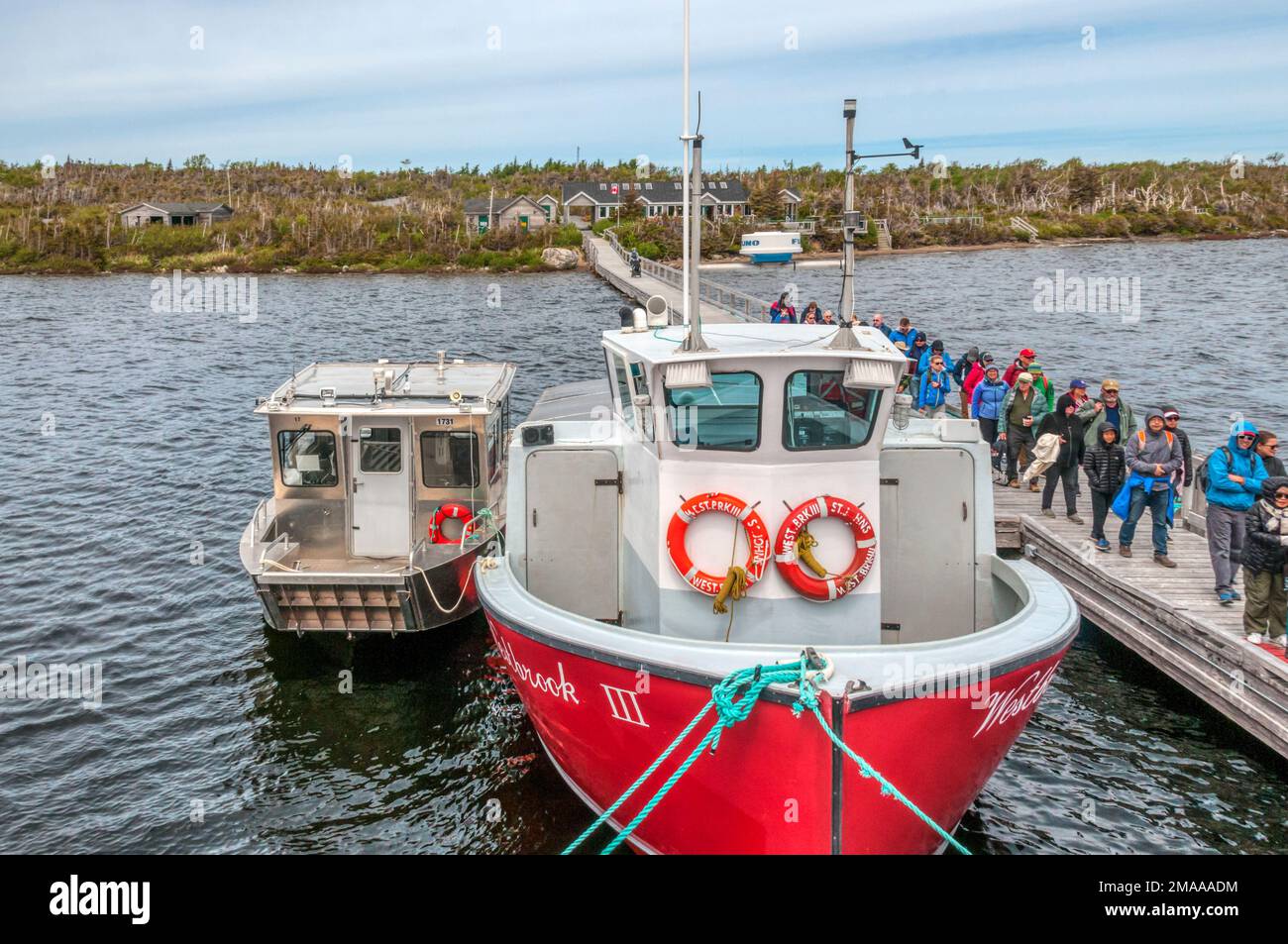 Tourists boarding boats at Western Brook Pond for a scenic boat trip in ...