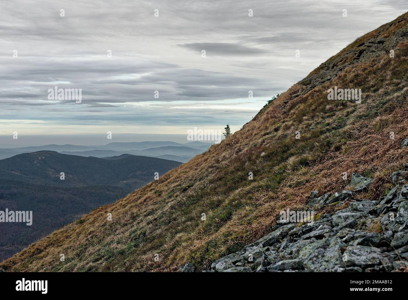 A close-up view of a hill with cloudy sky in background Stock Photo - Alamy