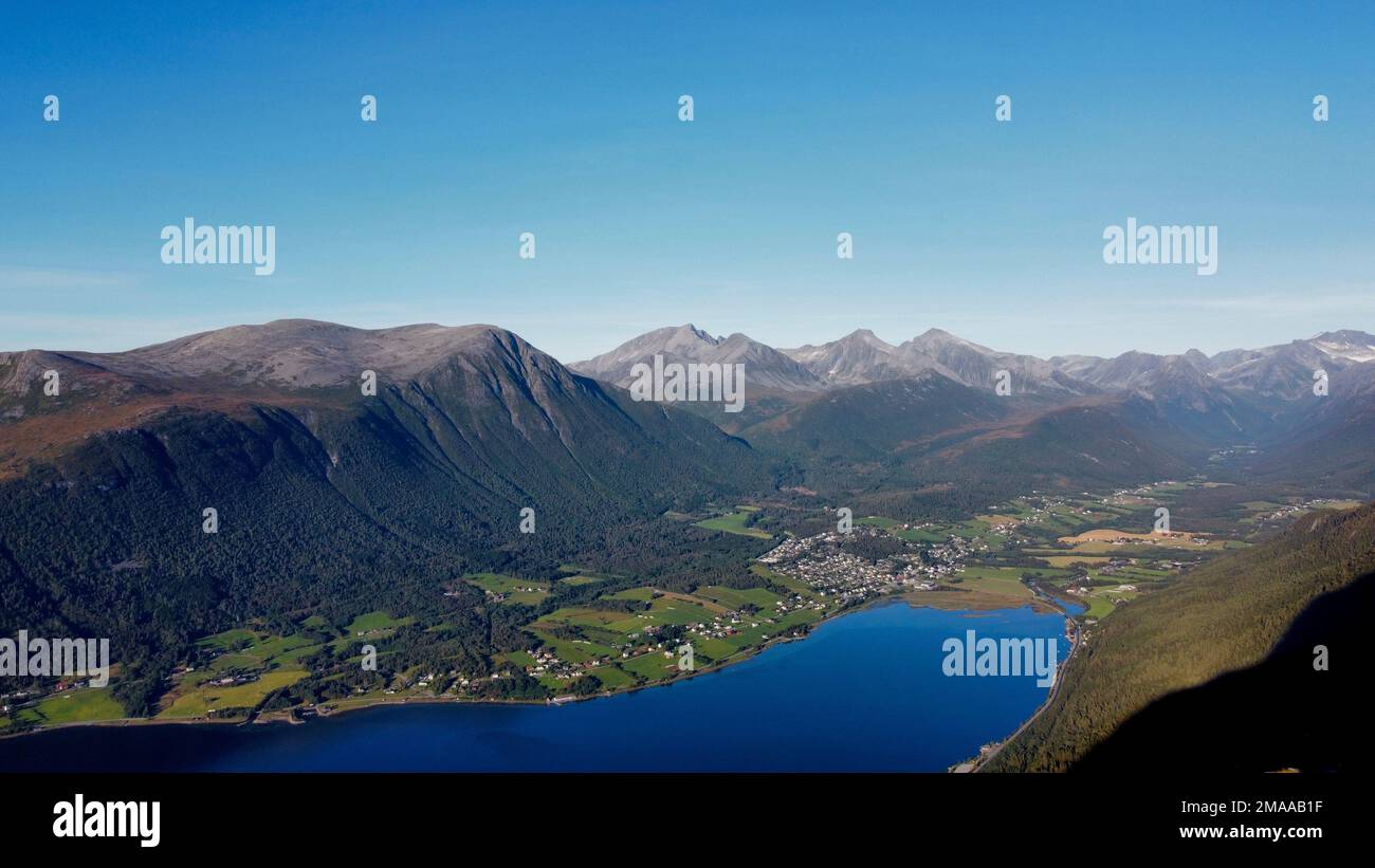 A landscape view of a blue lake surrounded with picturesque mountains ...