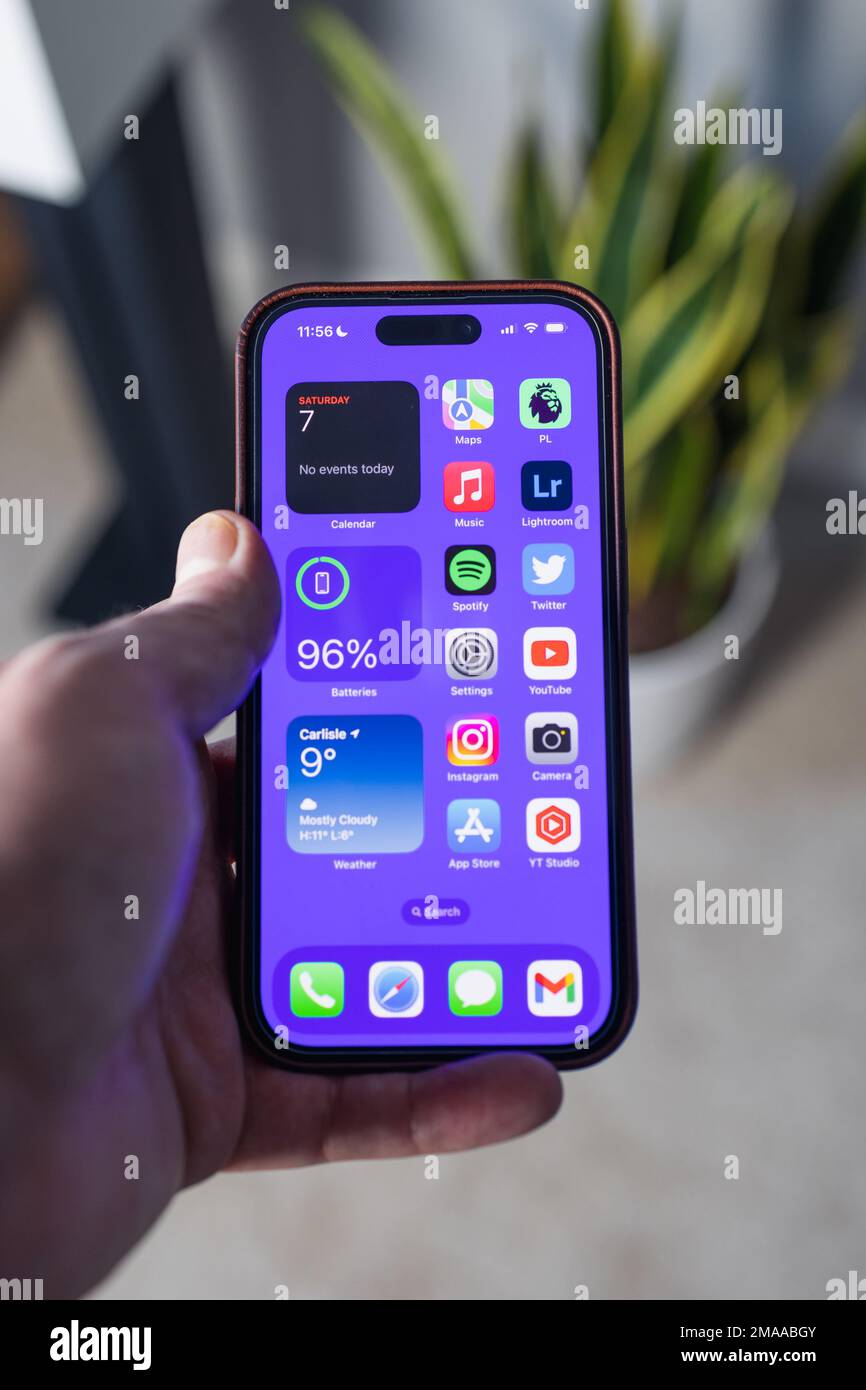 LONDON - JANUARY 07, 2023: Man holding Apple iPhone 14 Pro in hand with ...