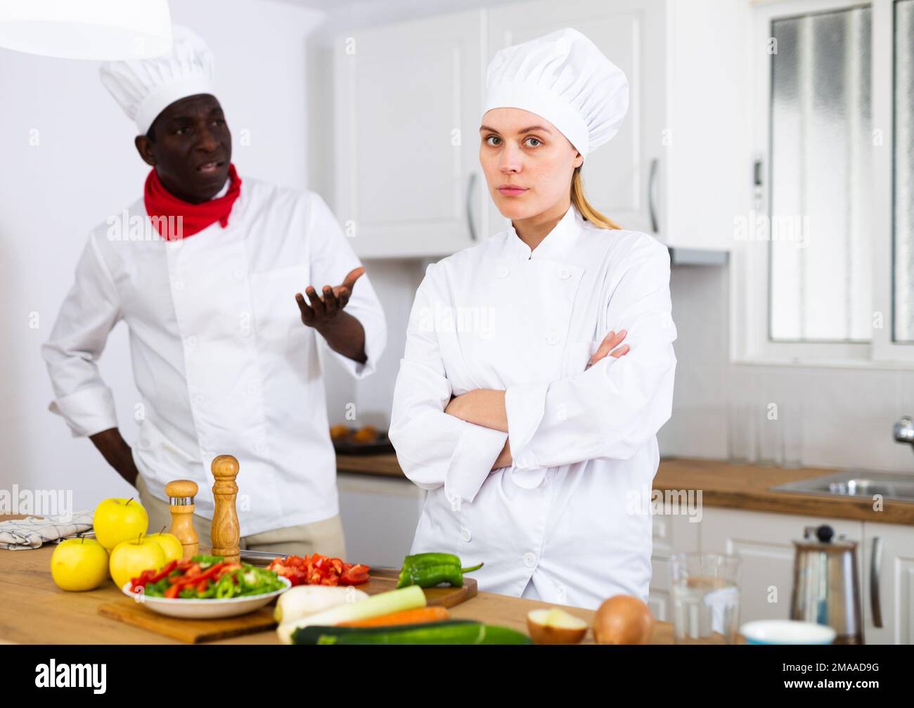 Cook and chef having quarrel in kitchen Stock Photo - Alamy