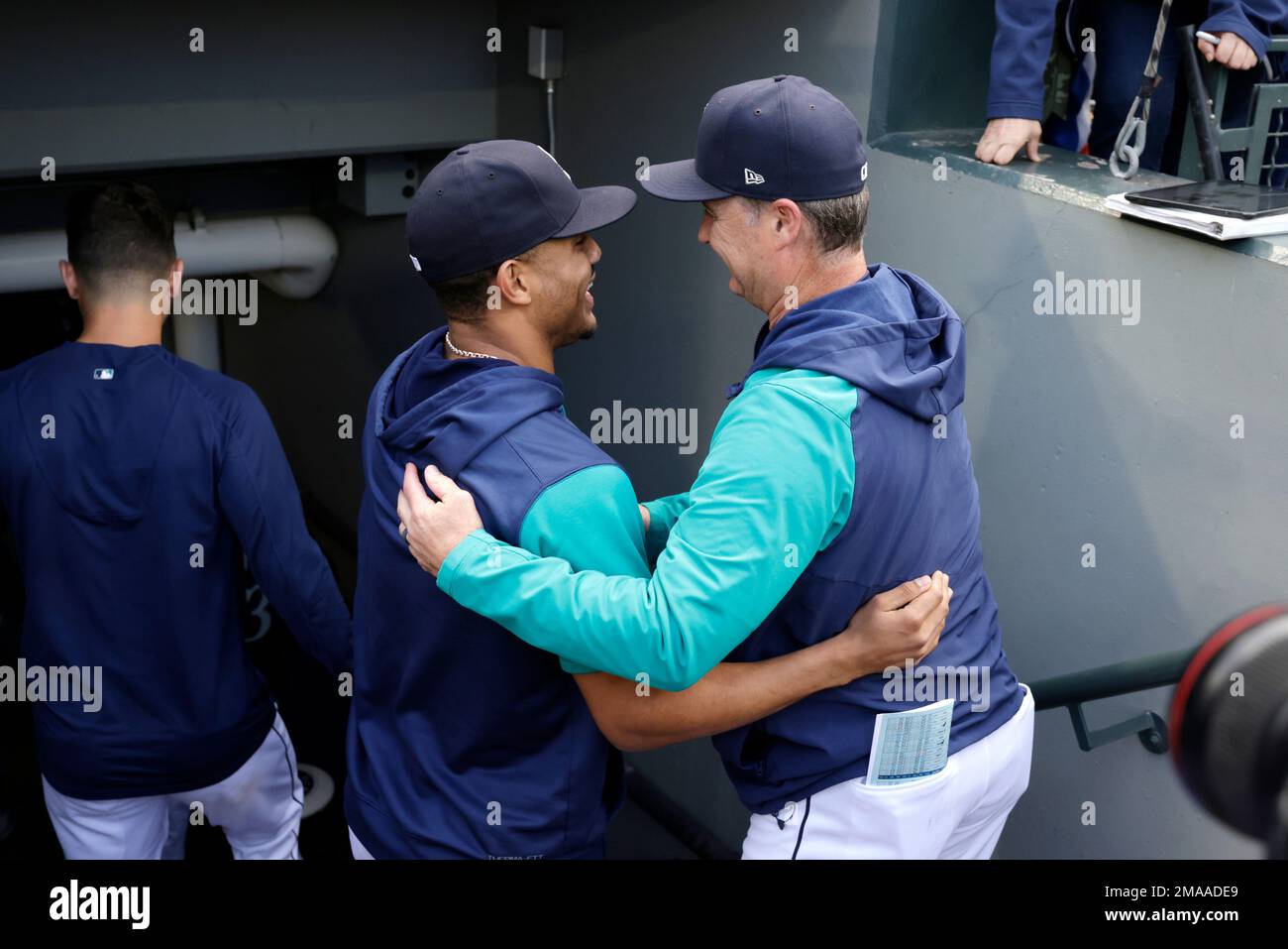 Seattle Mariners manager Scott Servais, right, hugs Julio Rodriguez as ...
