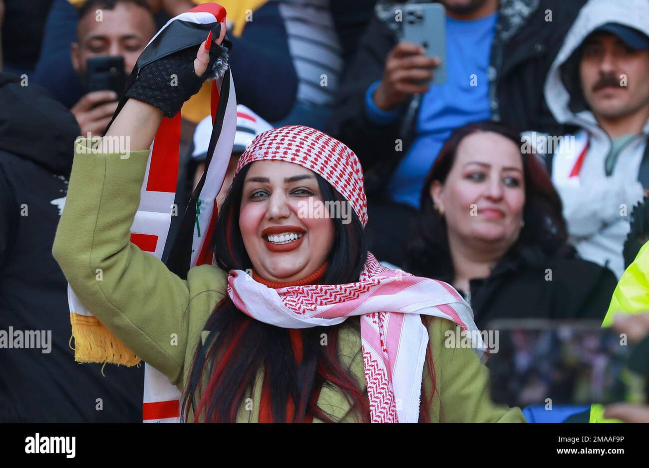 Iraqi soccer fan waves her country flag inside the stadium before the ...