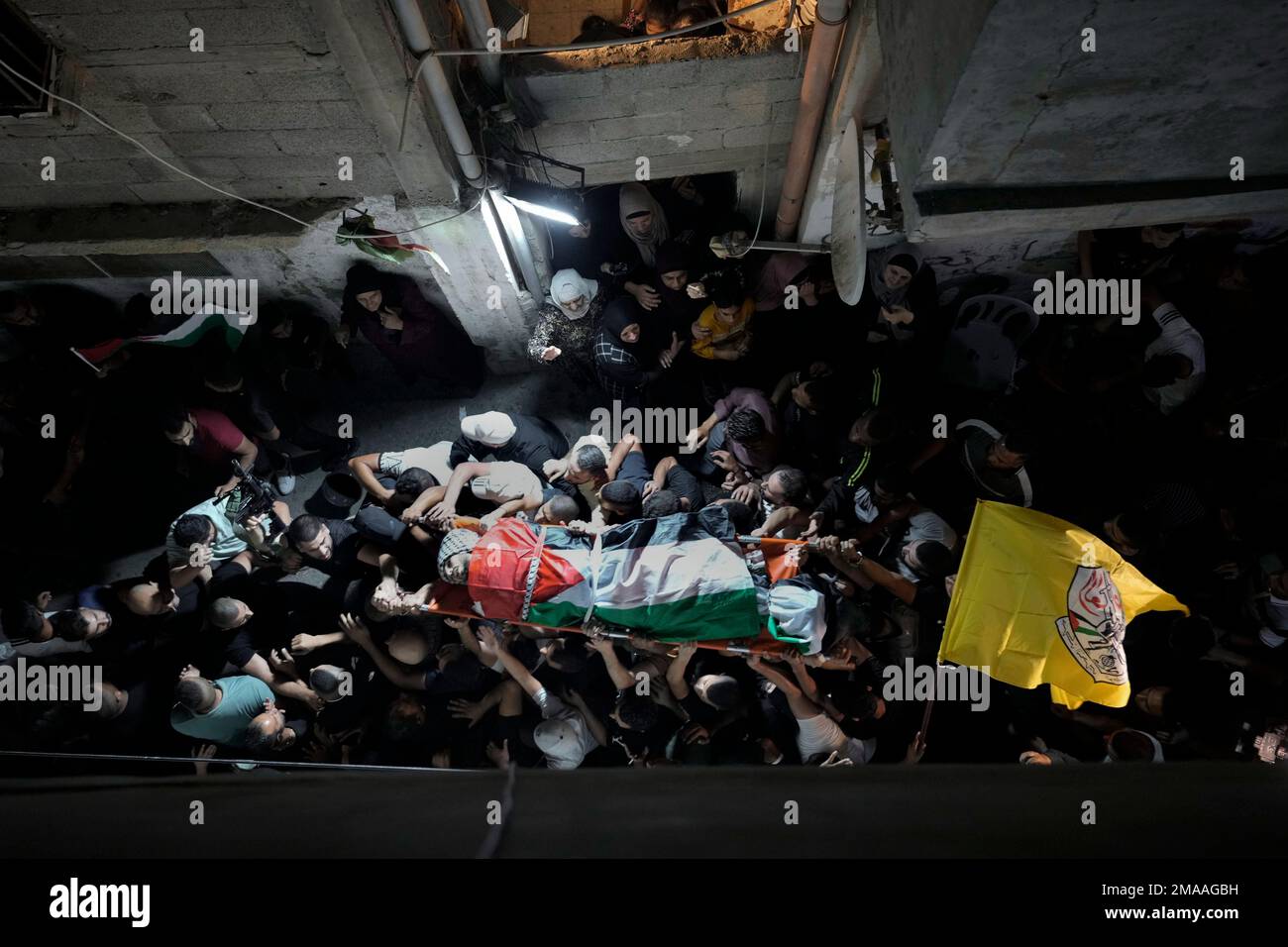 Mourners carry the body of Palestinian Alaa Zaghal during his funeral ...