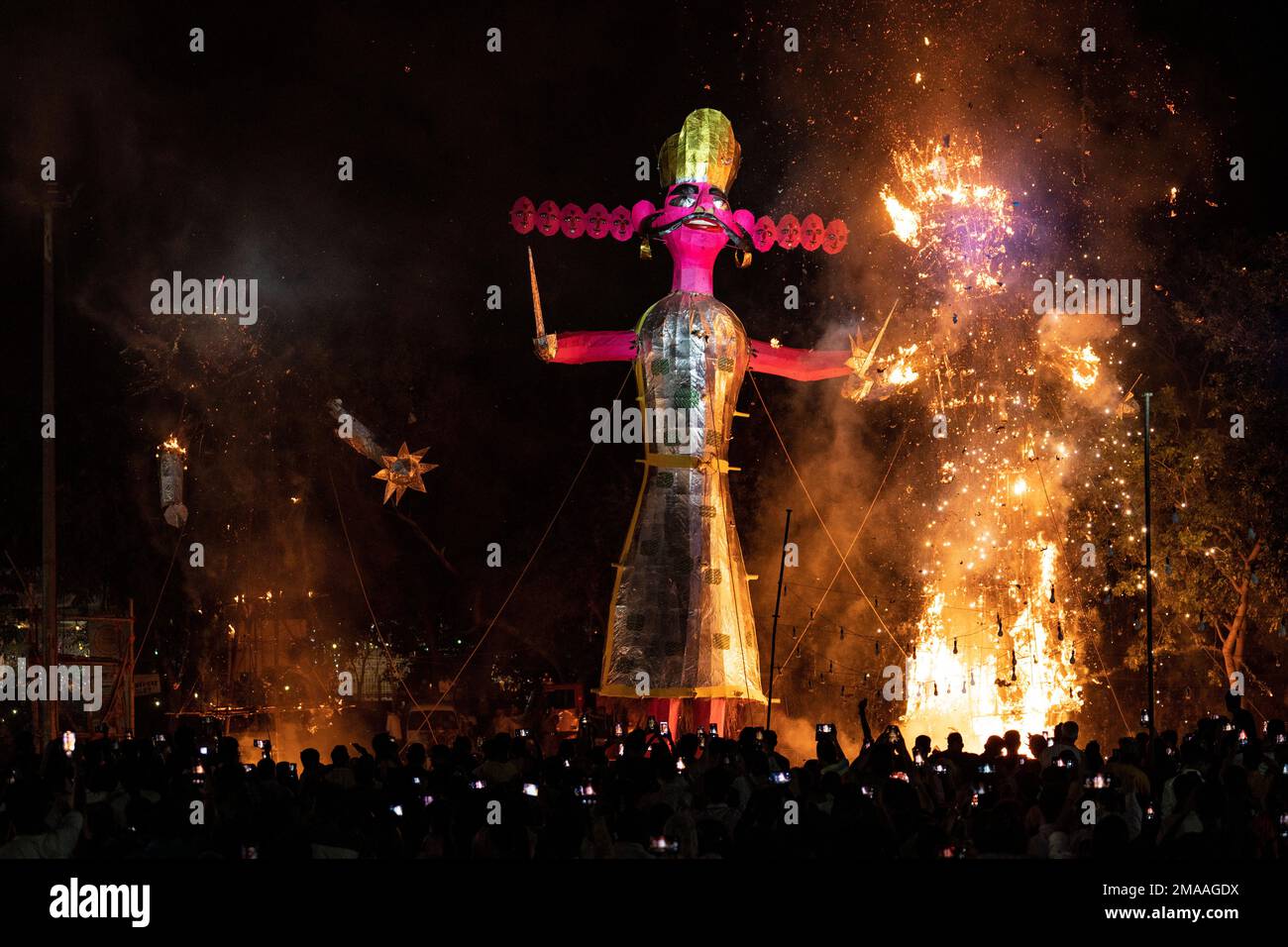 People watch the burning of effigies of demon king Ravana and his son ...
