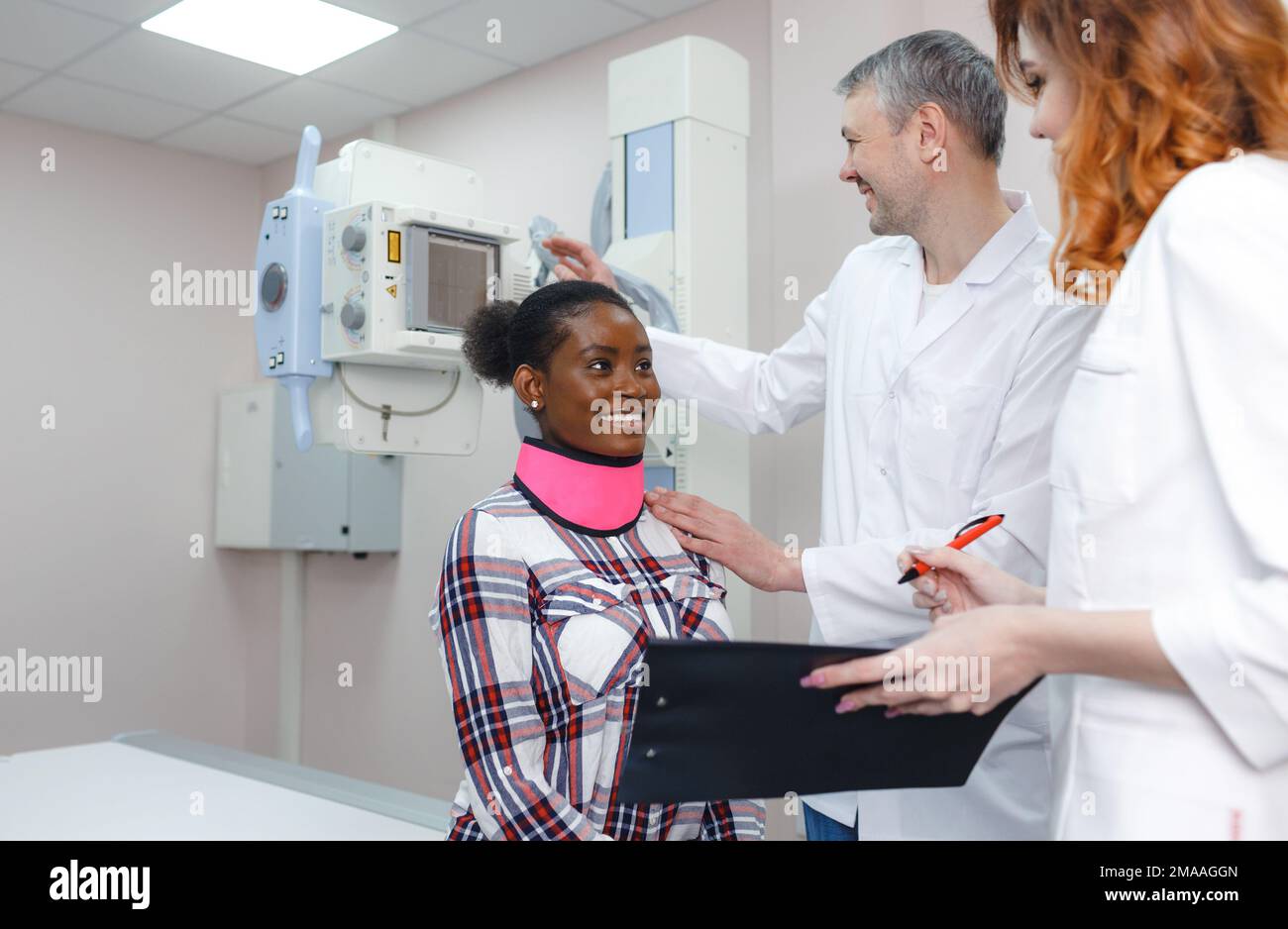 a radiologist together with an assistant prepares an African-American ...