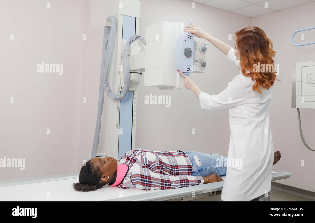 female radiologist technician, during a medical test and X-ray of a ...