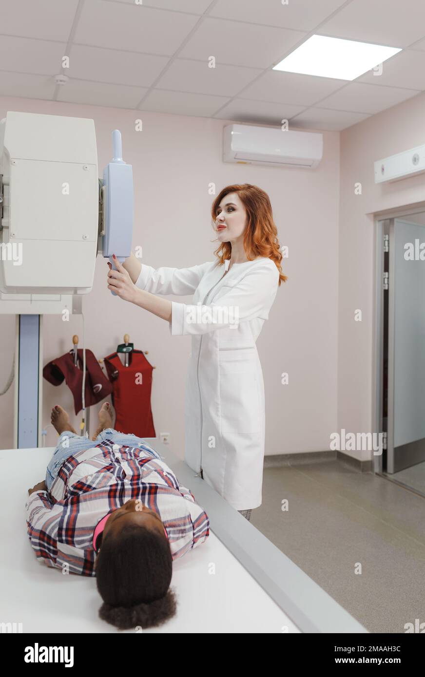 female radiologist technician, during a medical test and X-ray of a ...