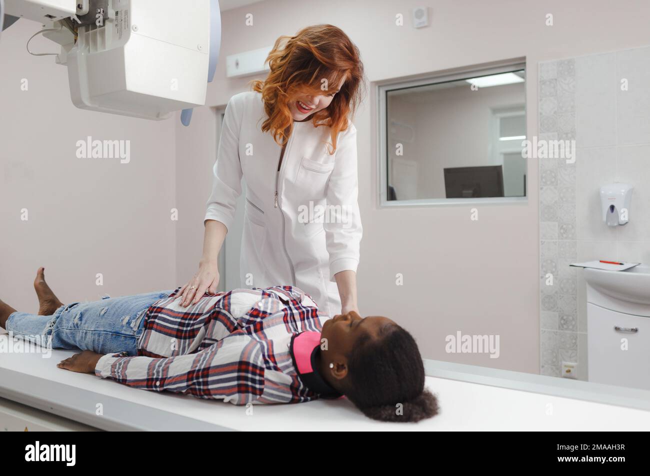 female radiologist technician, during a medical test and X-ray of a ...