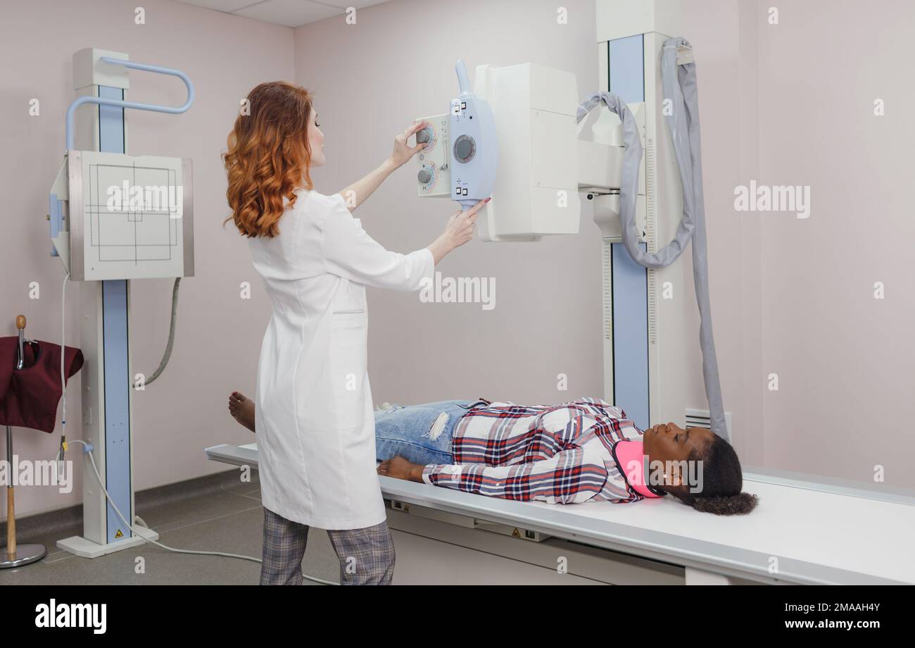 female radiologist technician, during a medical test and X-ray of a ...