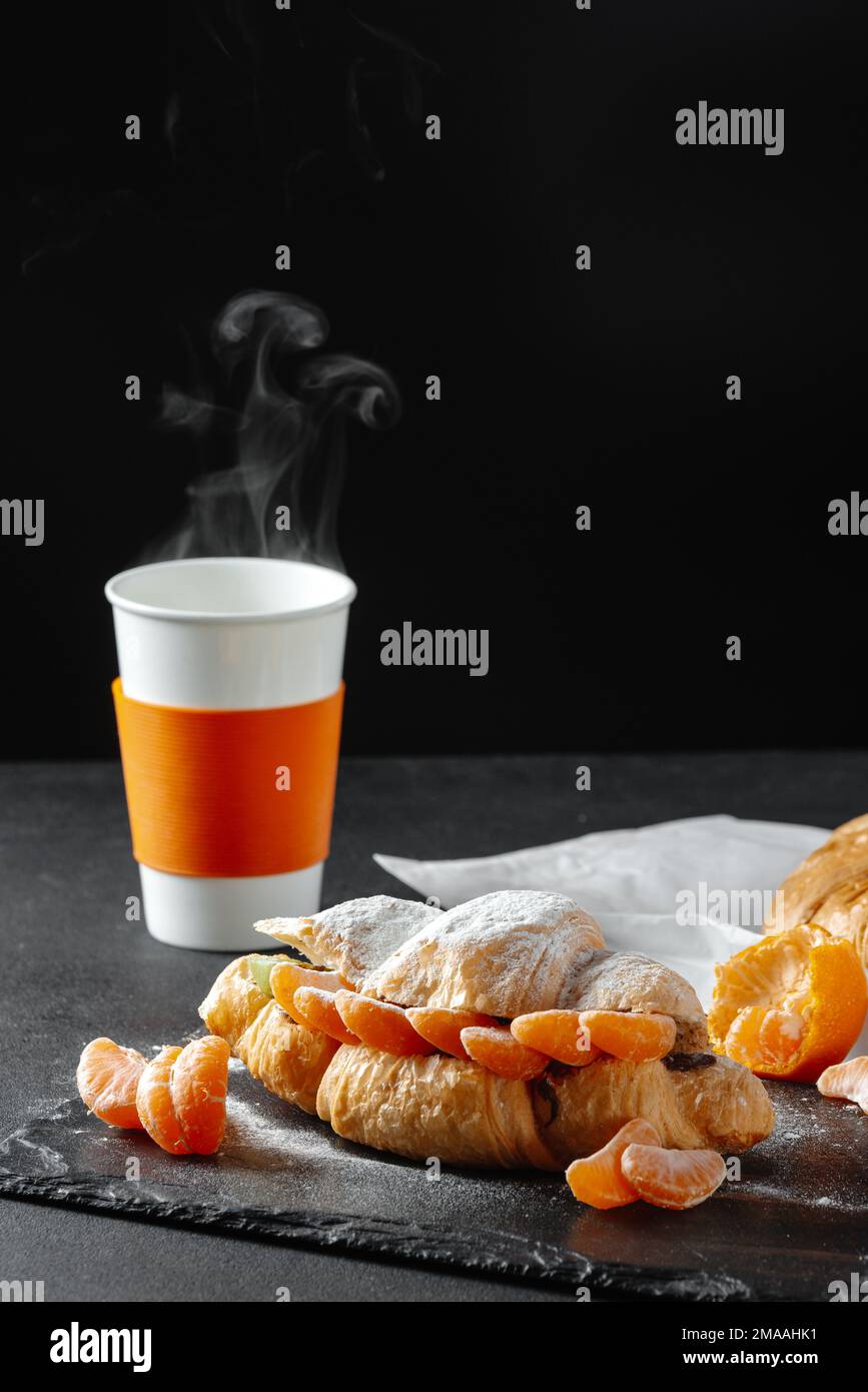 croissant with mandarins sweet on a dark background. Homemade ...