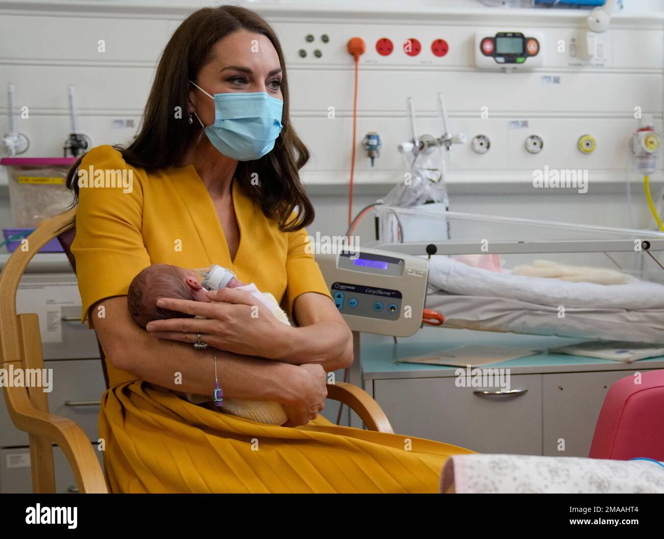 Britain's Kate, the Princess of Wales cradles baby Bianca as she speaks ...