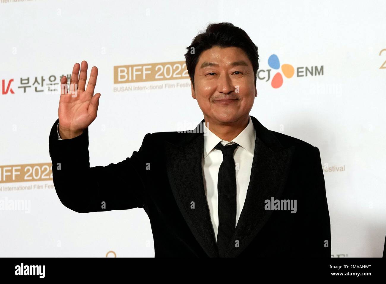 South Korean actor Song Kang-ho wave as he arrives to attend the opening ceremony of the 27th ...