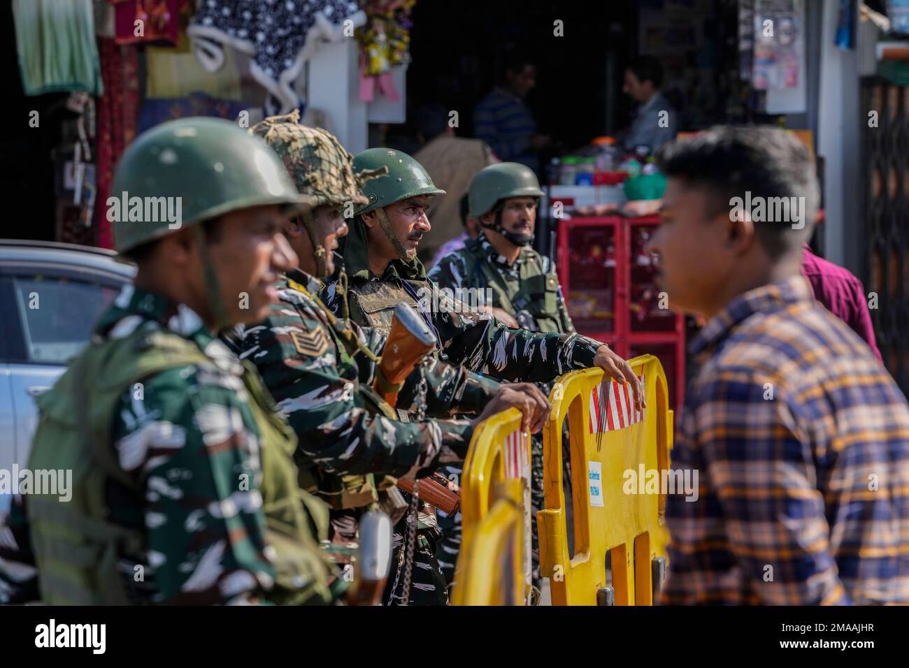 Paramilitary soldiers guard as tourists ask permission to cross a ...