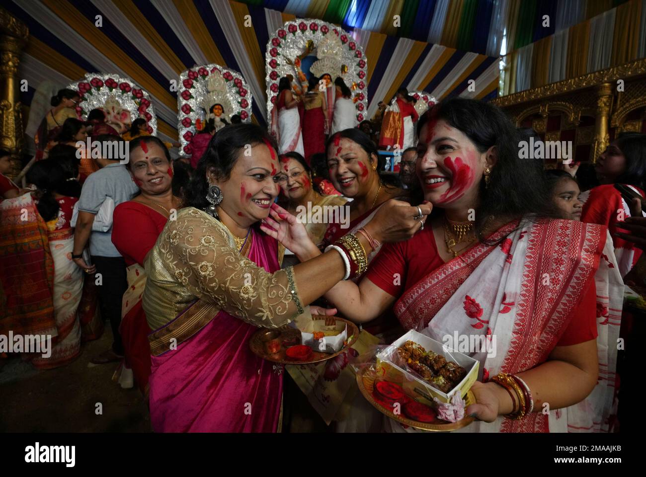Hindu women smear vermilion powder each other's faces during Durga Puja ...