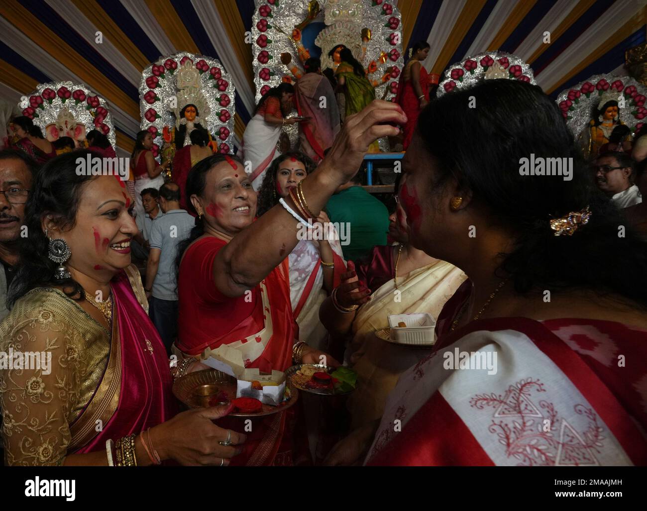 Hindu women smear vermilion powder each other's faces during Durga Puja ...