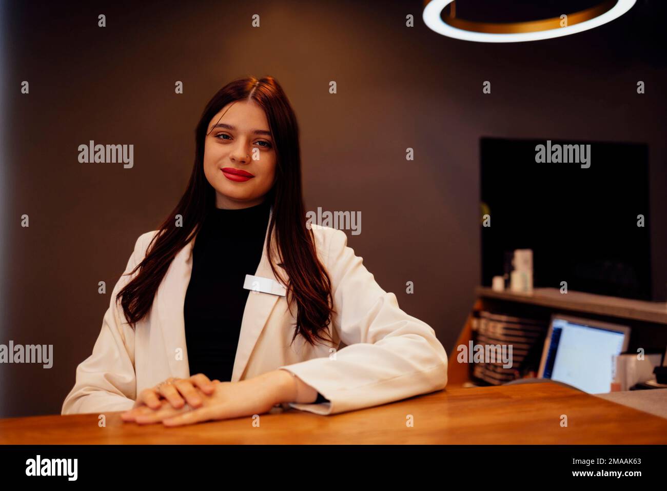 Brunette woman receptionist working in Reception area of the beauty ...