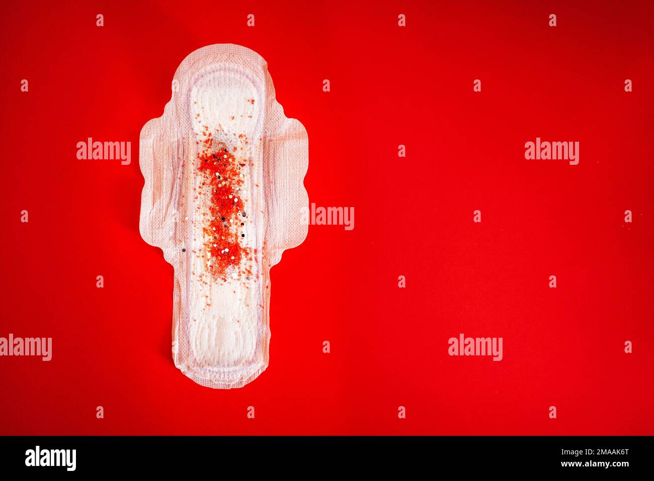 Menstrual pad with red and silver sequins on a red background, free ...