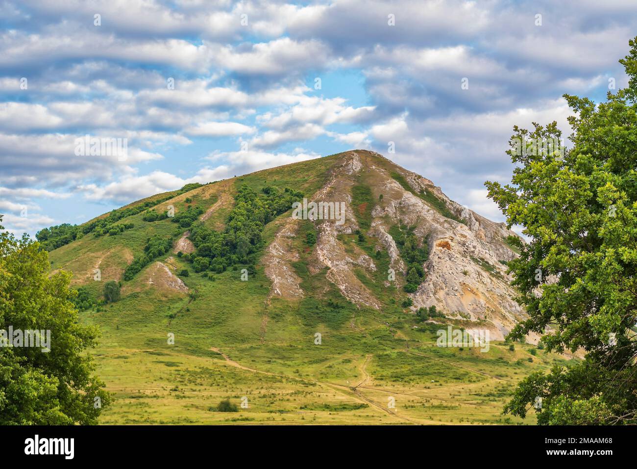 Summer landscape with green pasture, ancient relic mountain Shihan ...