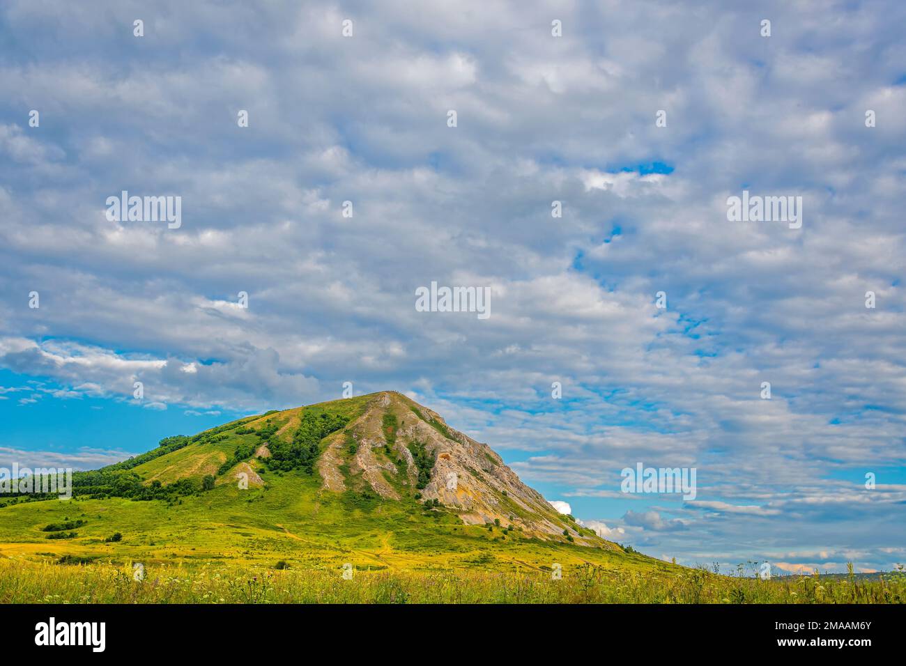 Green valley with pasture, relic mountain Shihan, blue cloudy sky in ...