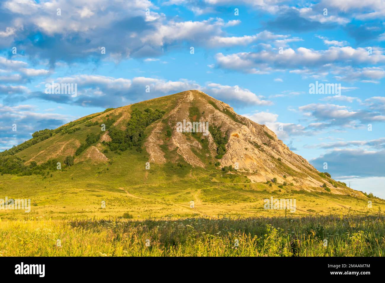 Summer landscape with green pasture, ancient relic mountain Shihan ...
