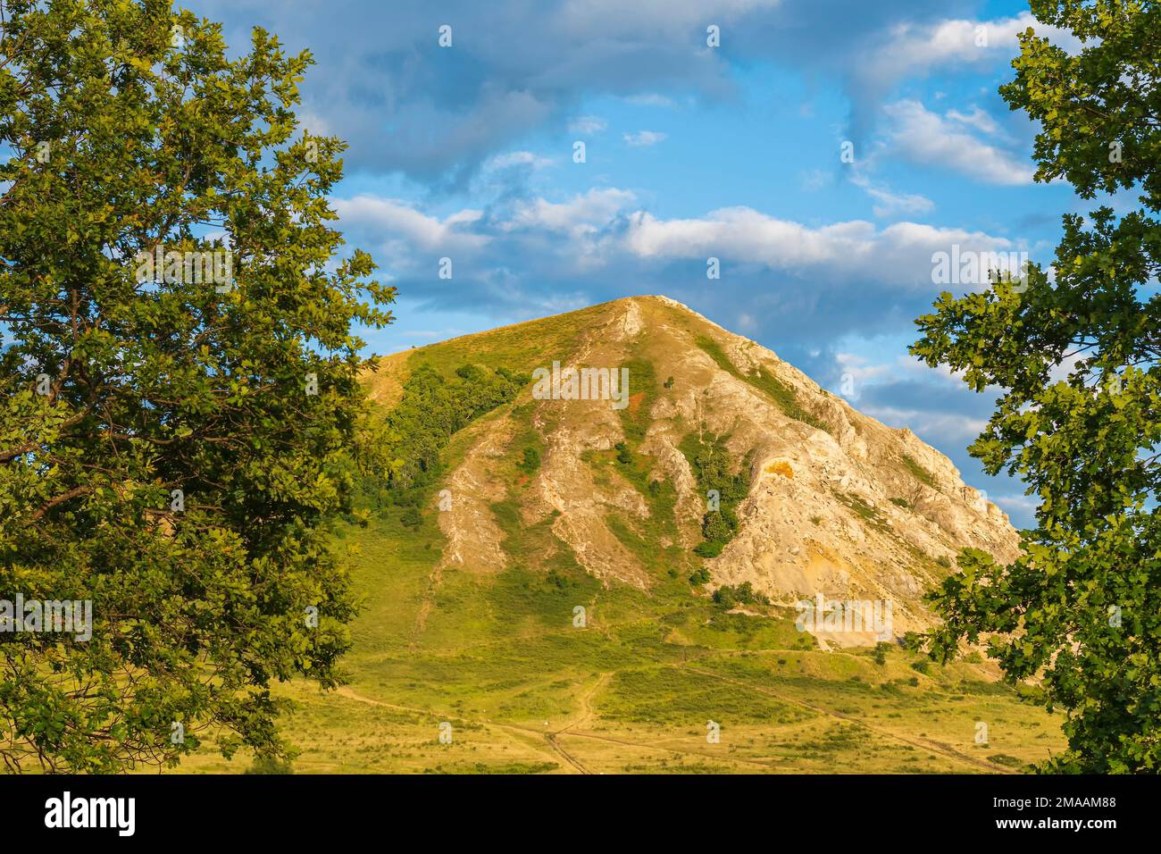 Summer landscape with green pasture, ancient relic mountain Shihan ...