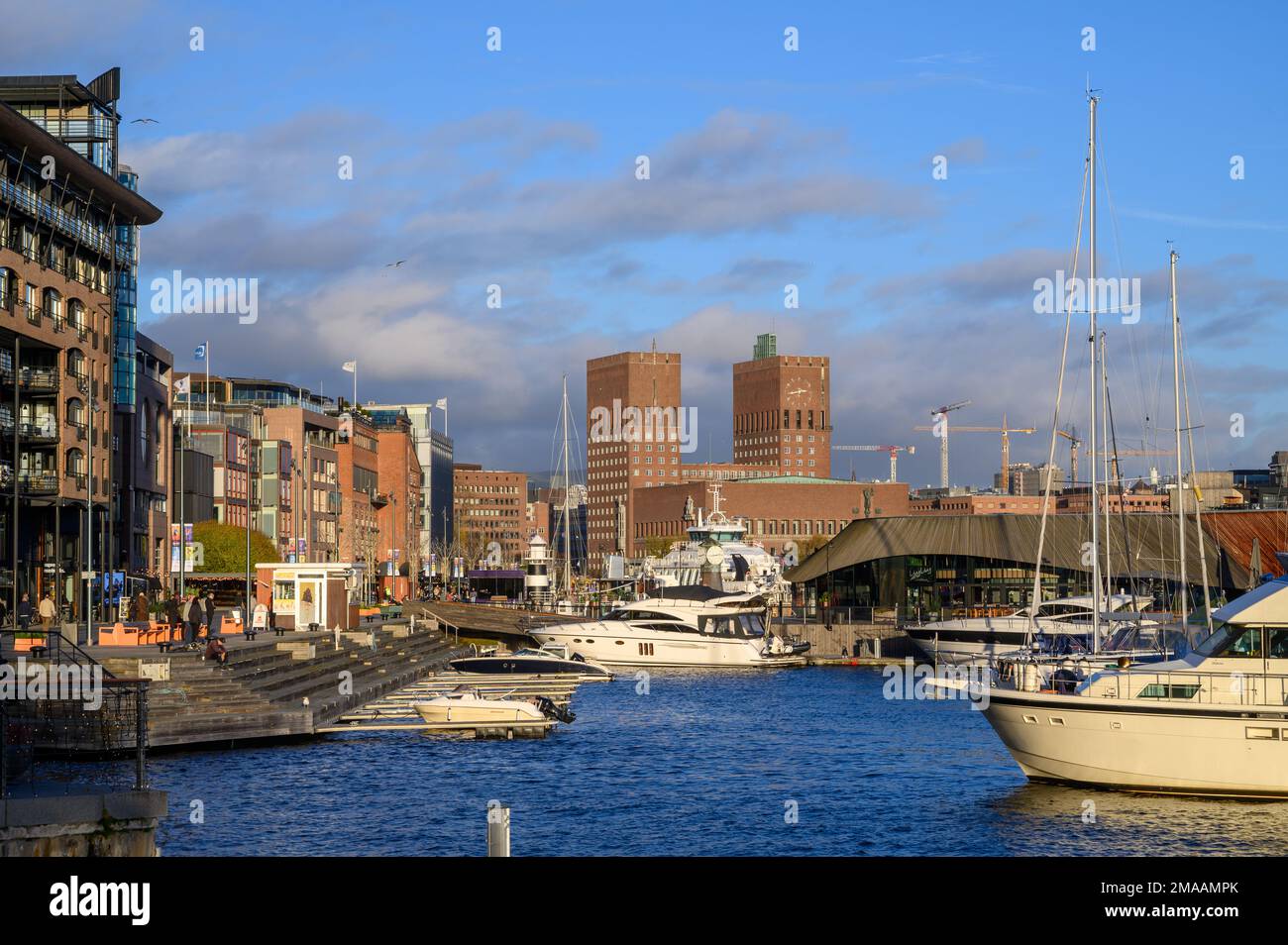 Aker Brygge with marina and the town hall in the background, Oslo ...