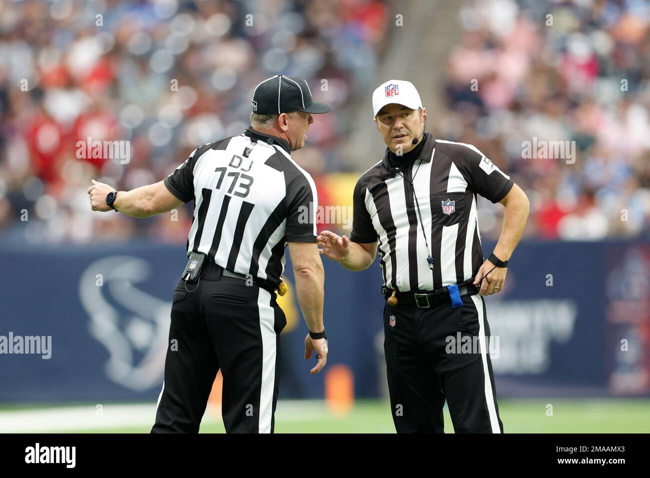 NFL official, referee Alex Kemp (55) talks with down judge Danny Short ...