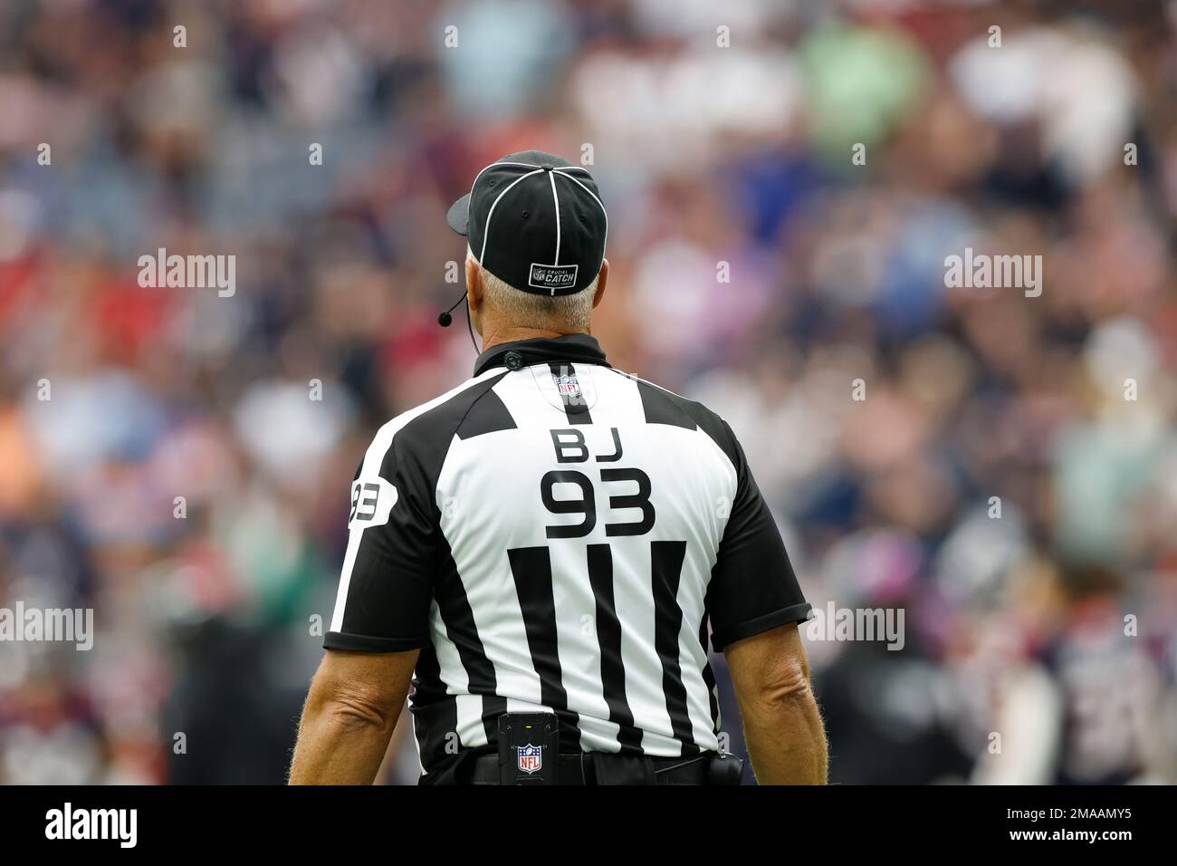 NFL official, back judge Scott Helverson (93) wearing a crucial catch ...