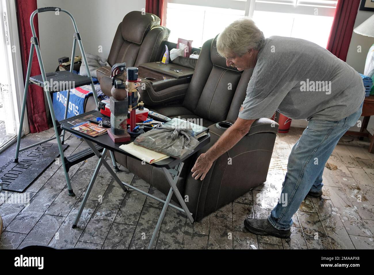 Ron Audette removes water logged furniture out of his damaged home ...