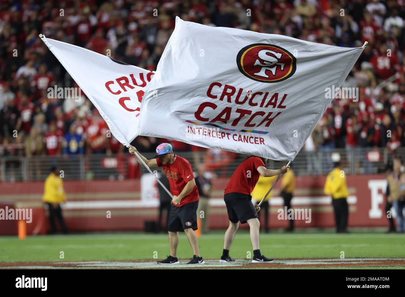 Crucial Catch logos are shown on flags during an NFL football game ...