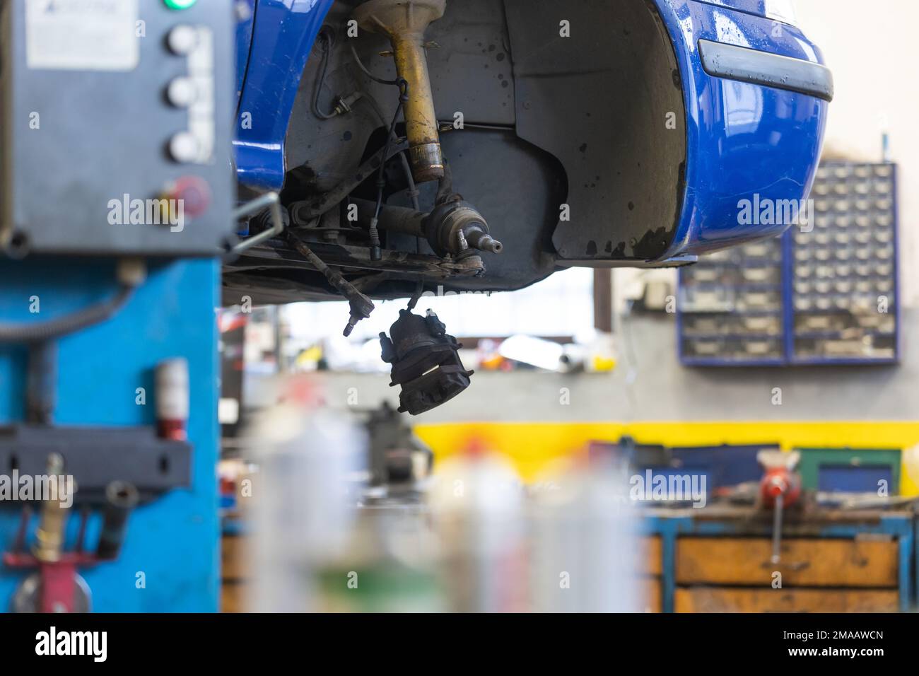 Car service center concept, vehicle raised on lift at maintenance ...
