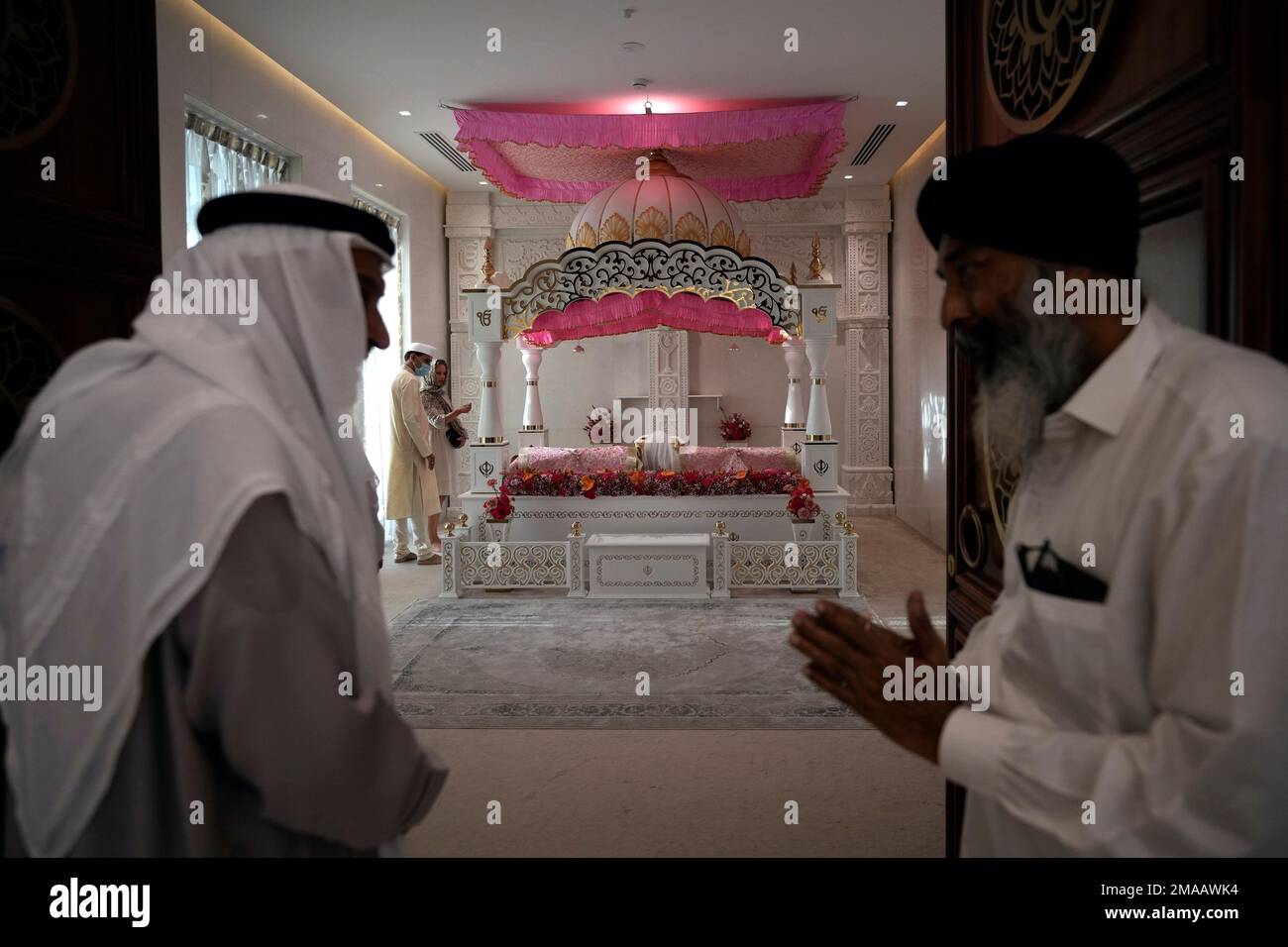 A Hindu priest greats an Emirati guest during the opening ceremony of ...