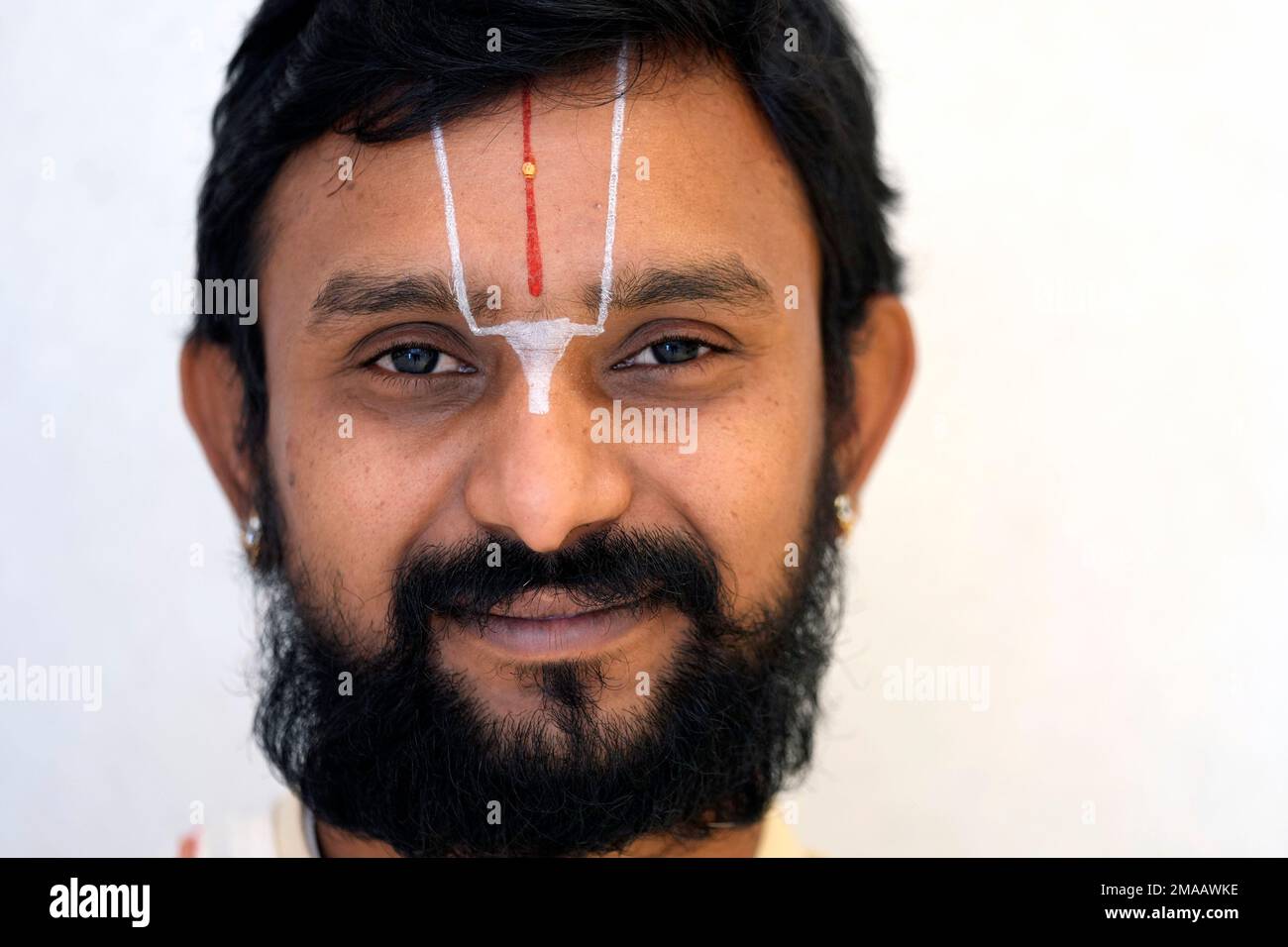 A Hindu priest poses during the opening ceremony of the new Hindu ...
